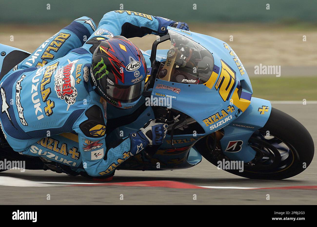 MotoGP rider John Hopkins of the United States powers up his Suzuki ...