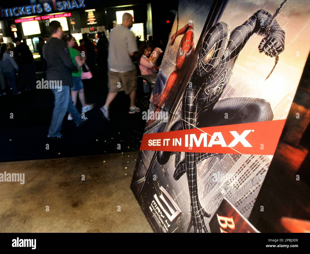 Movie-goers pass a poster featuring Spiderman 3 at Jordan's IMAX ...
