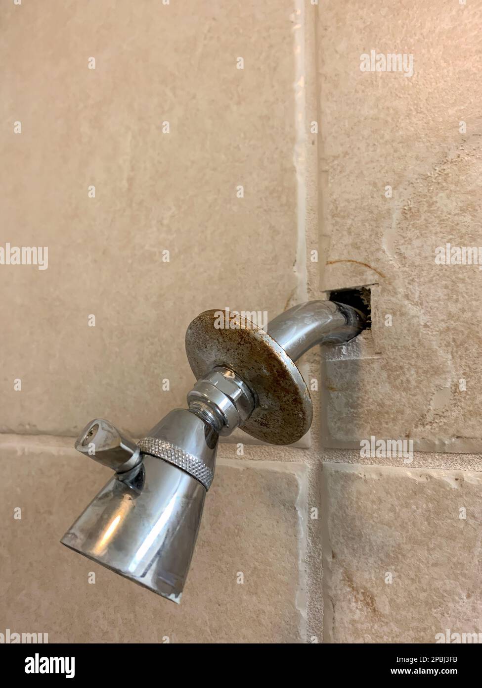 Hole cut into tile with a shower head protruding after installation ...