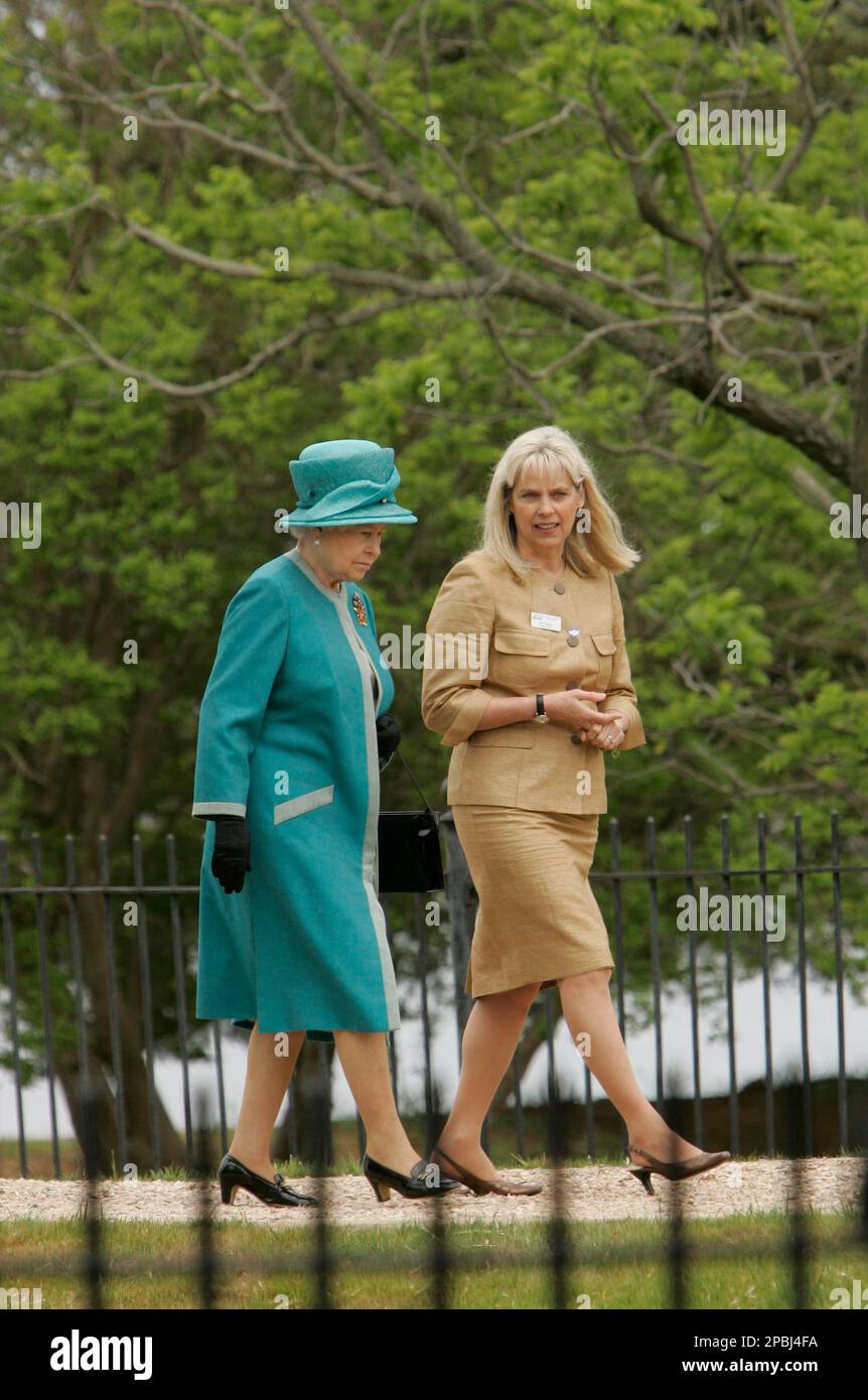 Queen Elizabeth II walks with museum curator Beverly Straube, right, as ...