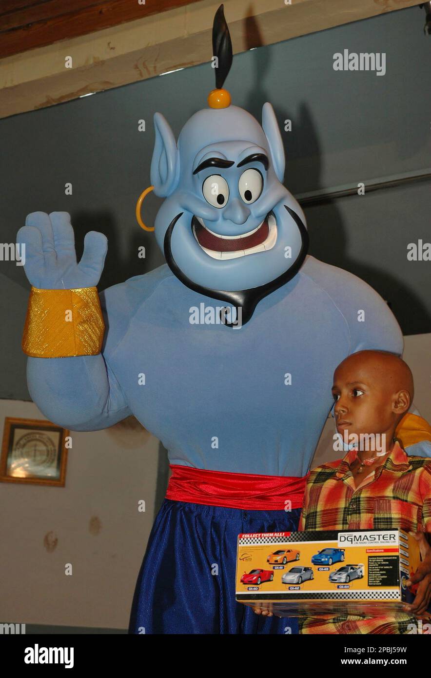 Walt Disney's magical character 'Genie', presents a gift to a child at ...