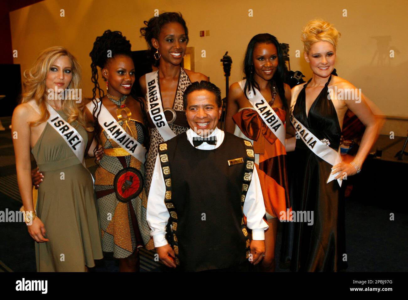 A waiter, unidentified, poses for photographers with, from left to ...
