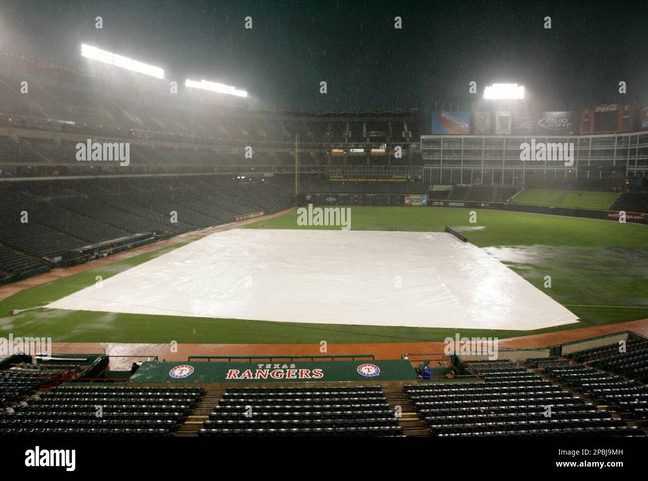 Water pools on the outfield as a severe storm moves in over the Rangers ...