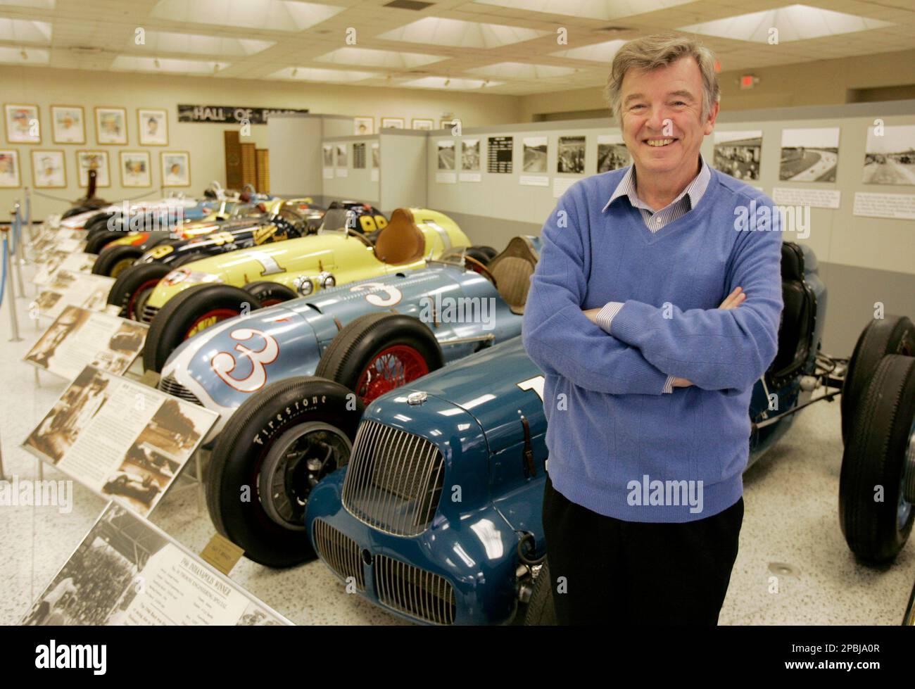 Speedway Historian Donald Davidson poses among old race cars on display ...