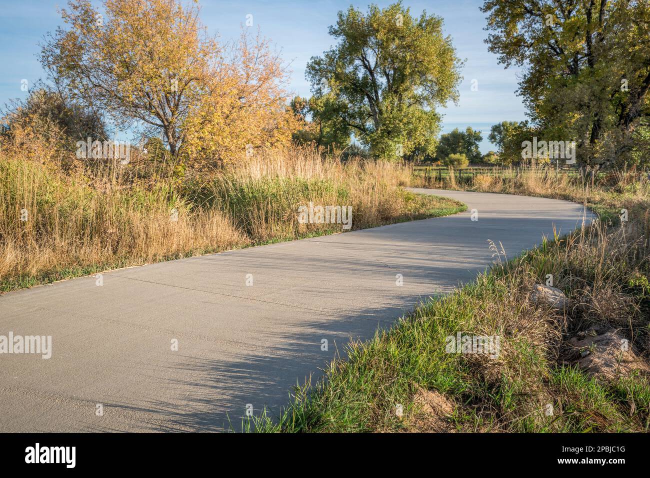 paved bike trail along the Poudre River in northern Colorado, fall scenery, recreation and ...