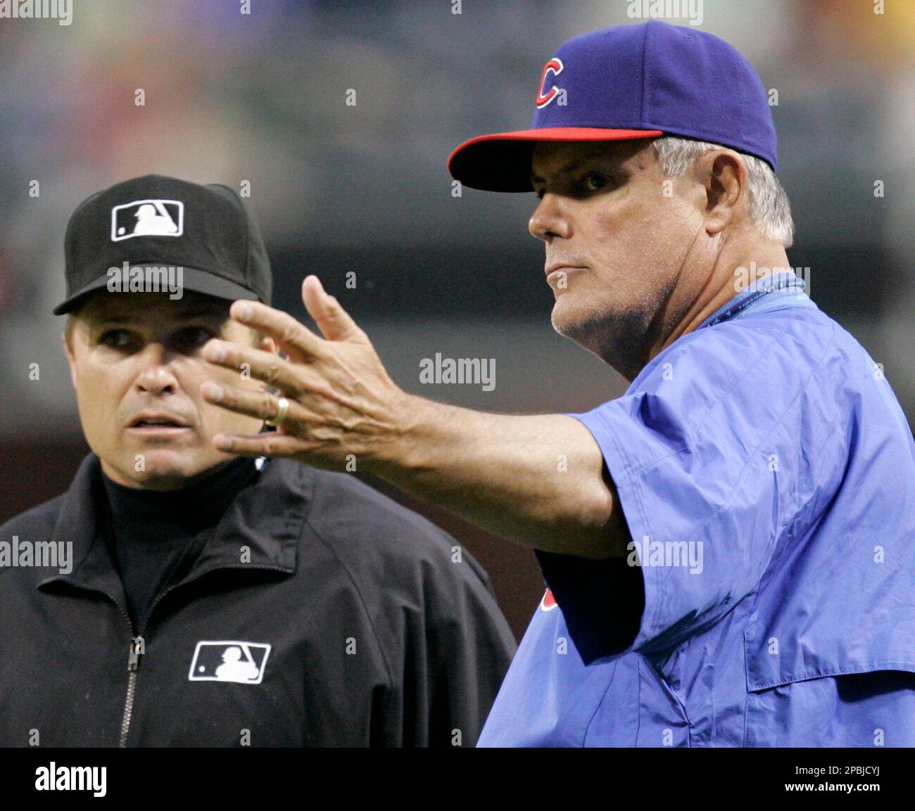 Chicago Cubs manager Lou Pinella, right, questions first base umpire ...