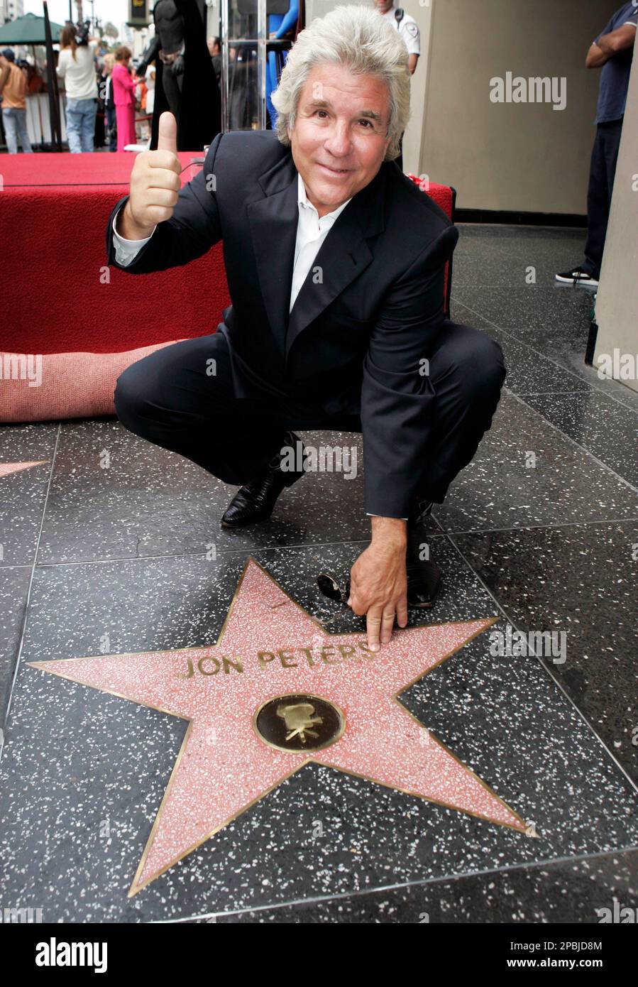 Hollywood producer Jon Peters poses with his new star on the Hollywood ...