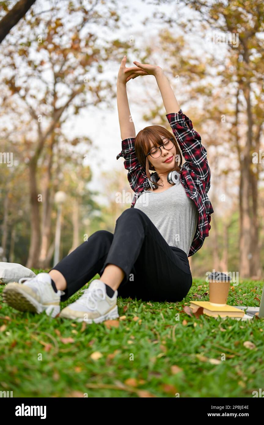 Portrait of a beautiful and relaxed young Asian female in casual ...