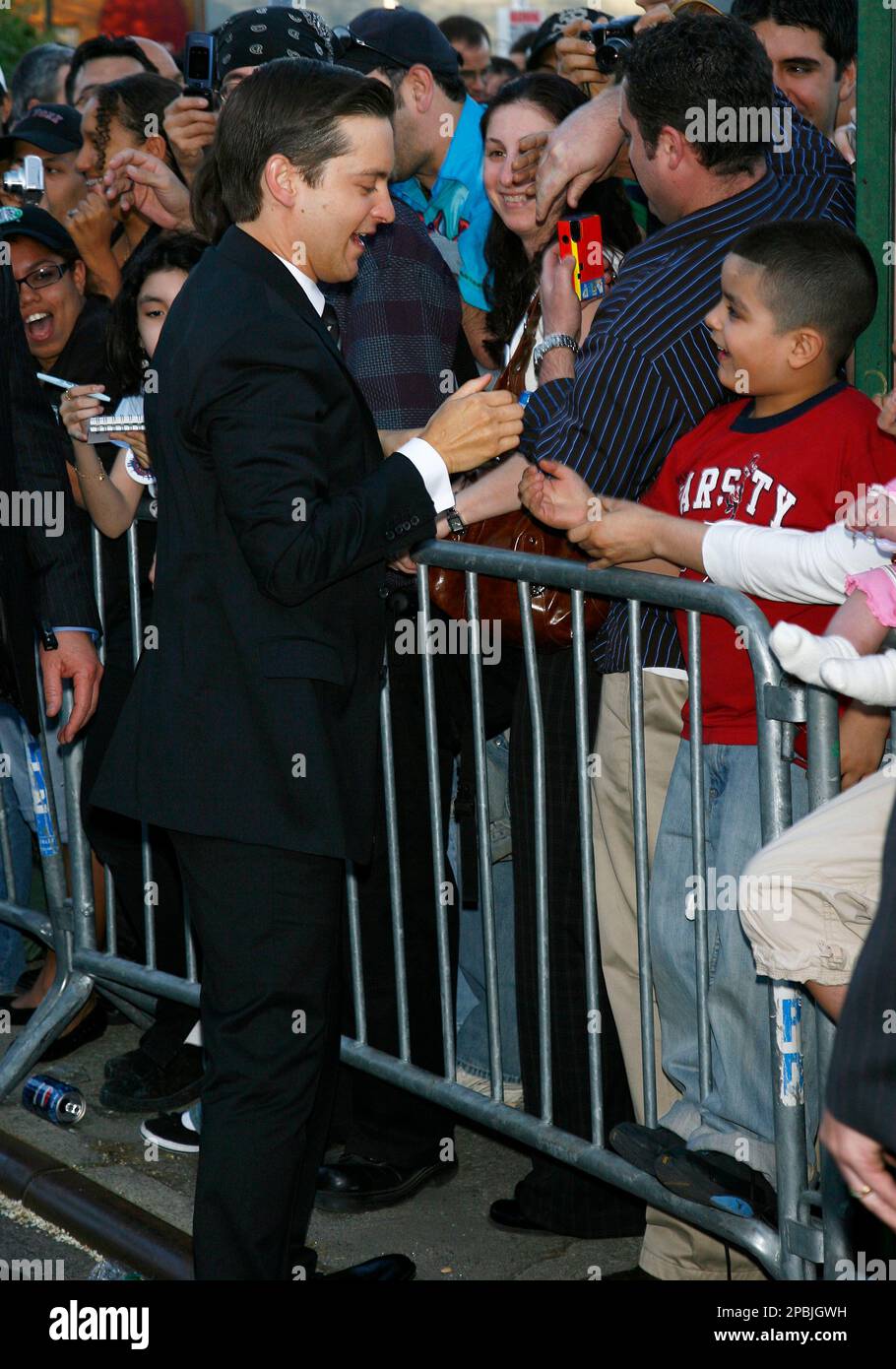 Actor Tobey Maguire greets fans as he arrives for the premiere of ...