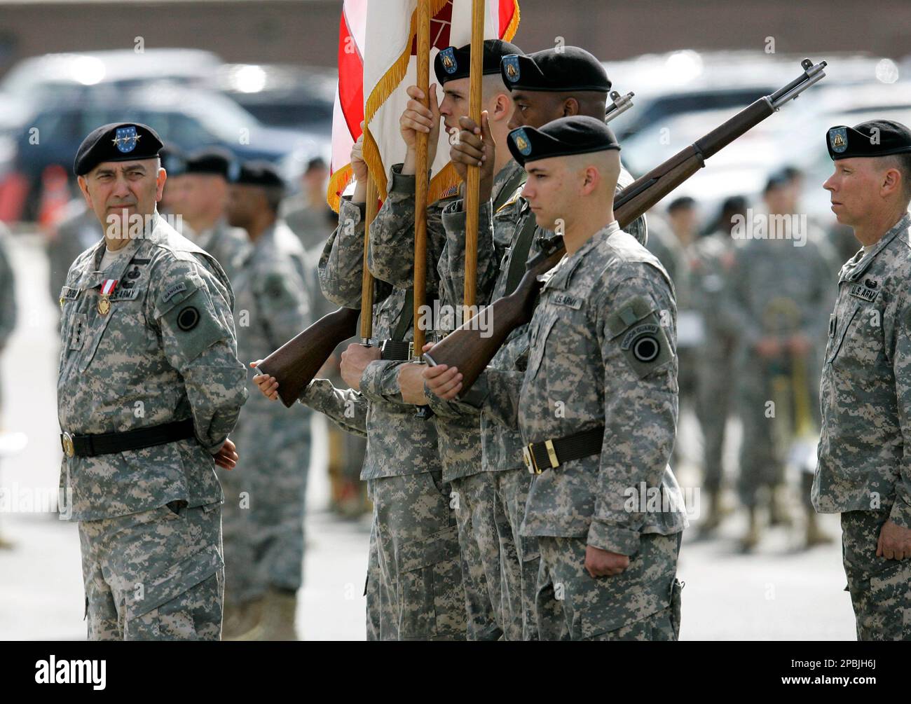 U.S. Army Lt. Gen. James Dubik, left, looks at soldiers in a flag ...