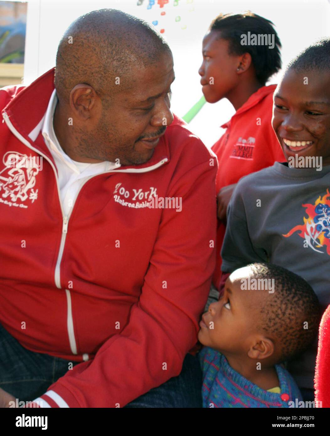 Academy award-winning actor Forest Whitaker, left, talks to children at ...