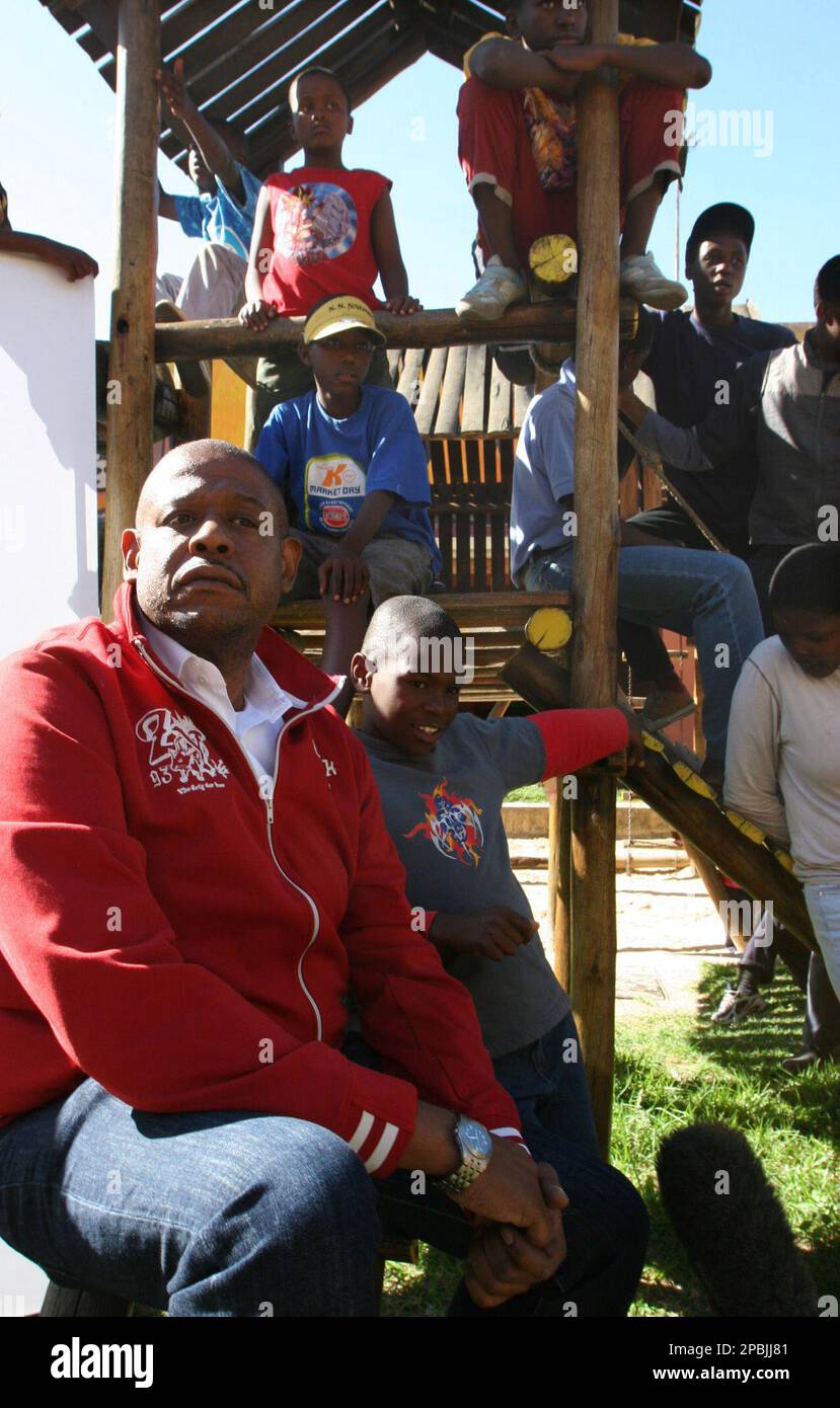 Academy award-winning actor Forest Whitaker, left, talks to children at ...