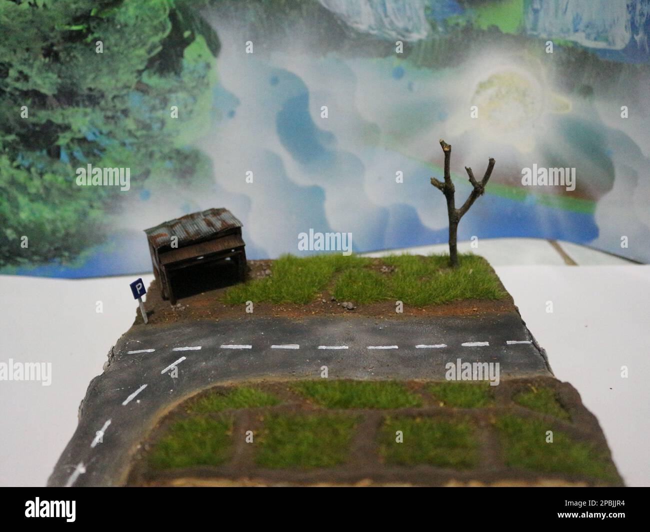 a close up of a diorama of a rice field scene and an old roadside house ...