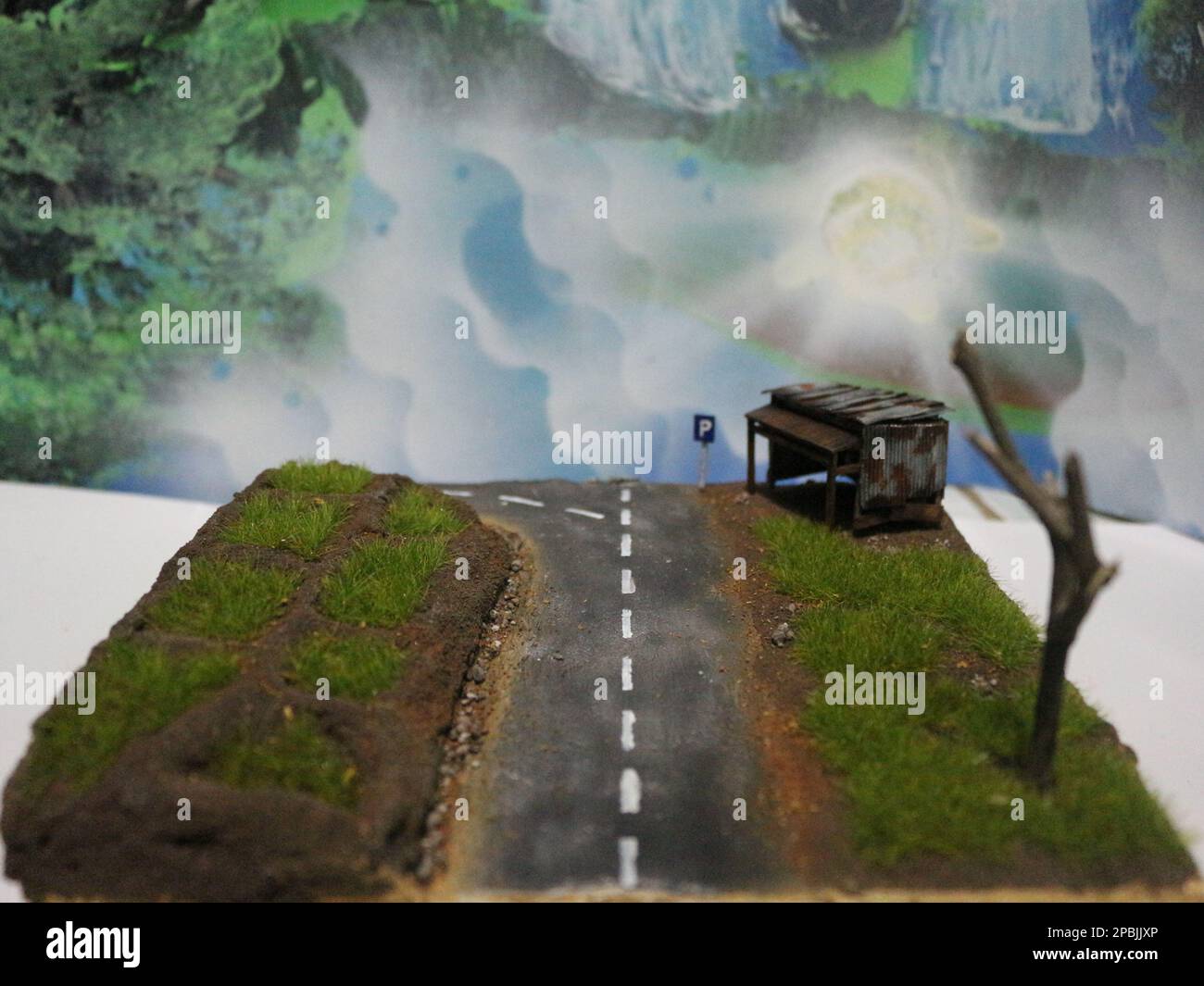 a close up of a diorama of a rice field scene and an old roadside house ...