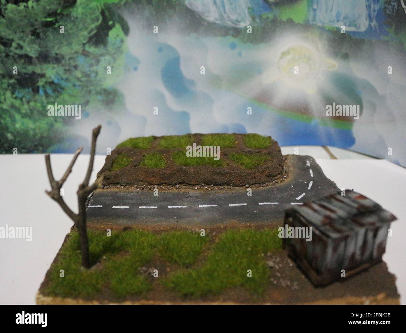 a close up of a diorama of a rice field scene and an old roadside house ...