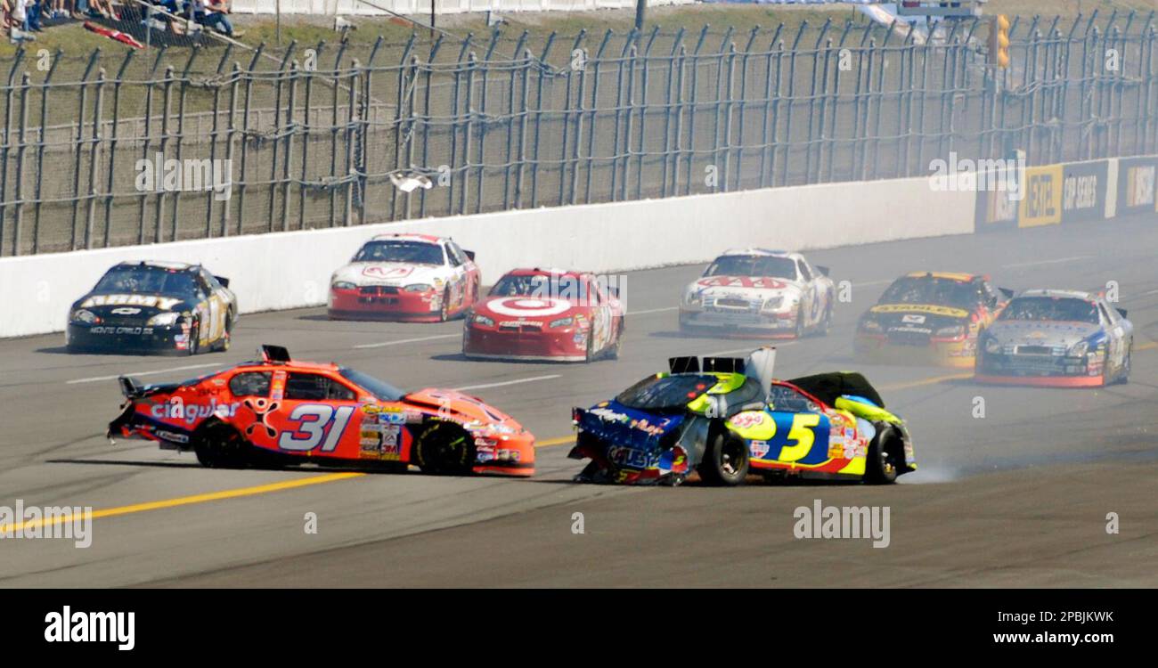 Drivers Jeff Burton (31) and Kyle Busch (5) crash on the back stretch ...