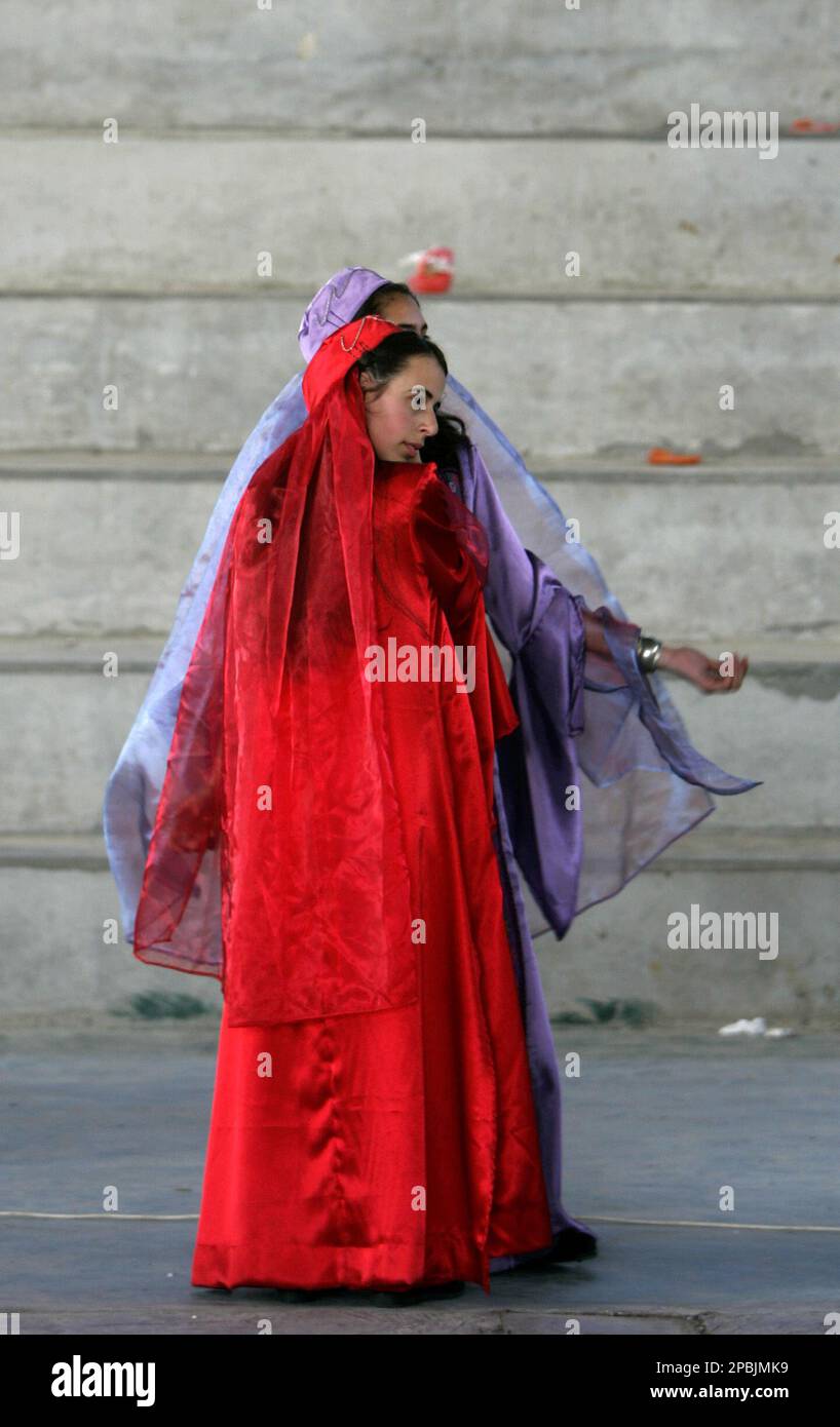 Palestinian dancers, wearing traditional clothes, perform a folk dance ...