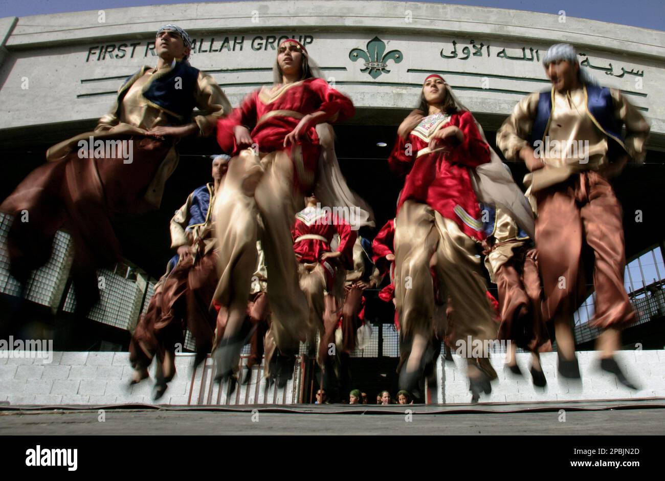 A group of Palestinian dancers, wearing traditional Palestinian clothes ...