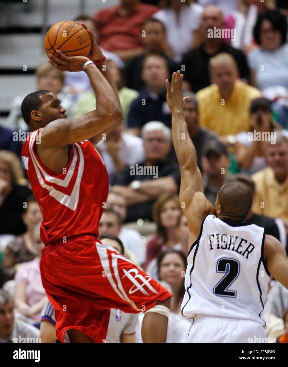 Houston Rockets forward Tracy McGrady, left, shoots against Utah Jazz ...