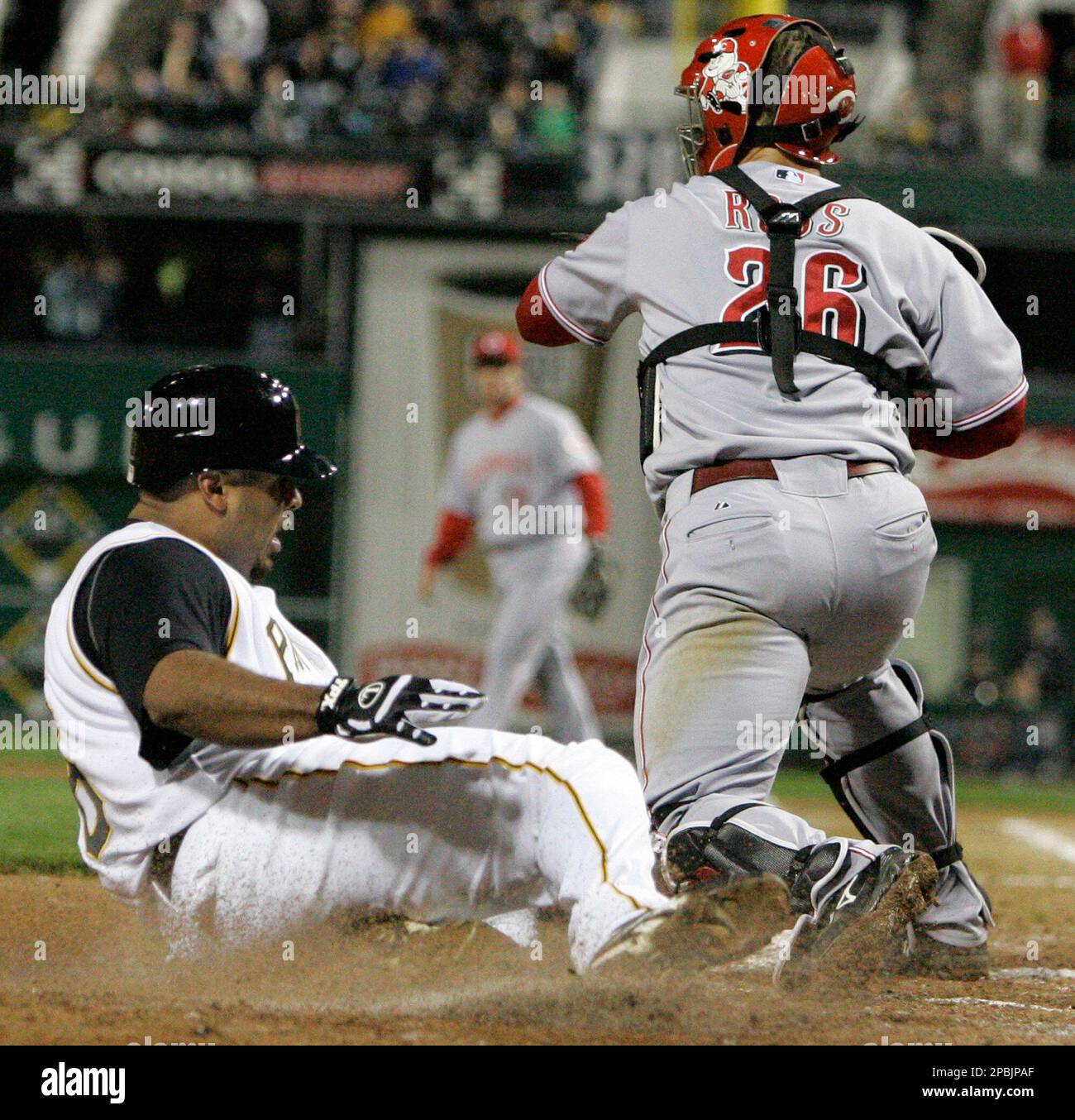 Pittsburgh Pirates' Ronny Paulino, left, scores the Pirates' only run ...