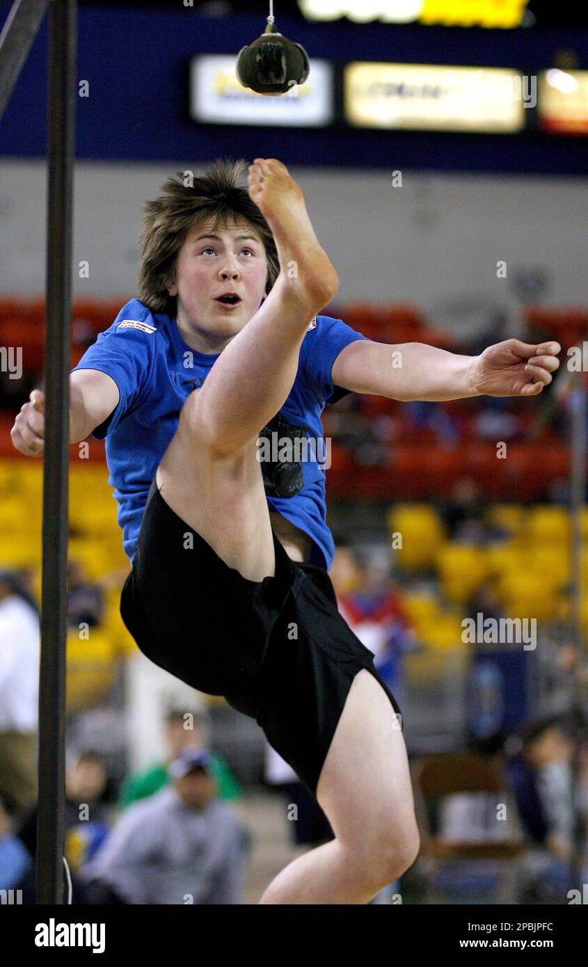 Chris Anderson, from Kenai, Alaska, jumps to kick a ball 90 inches from ...