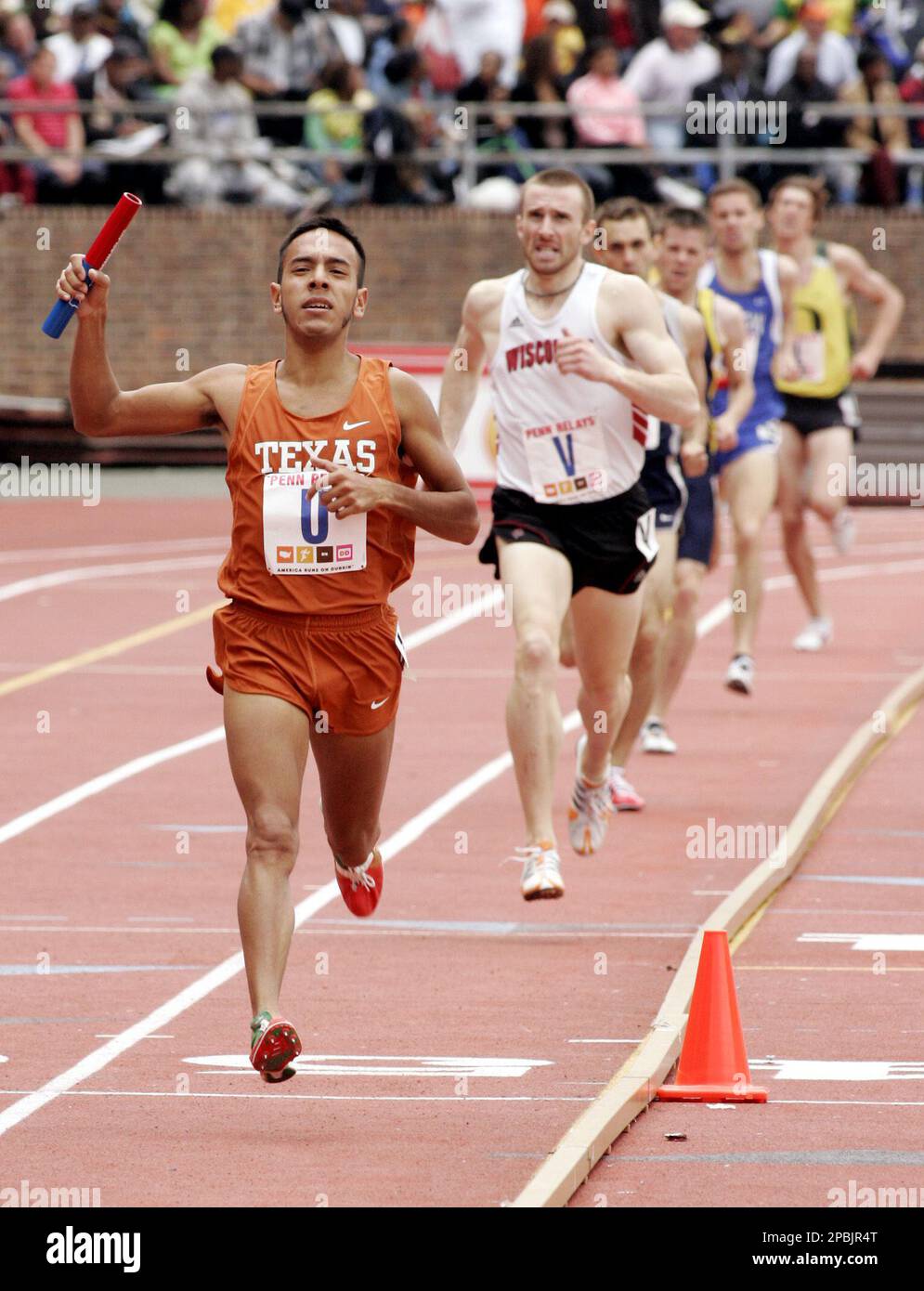 Texas anchor Leonel Manzano crosses the finish line to win the ...