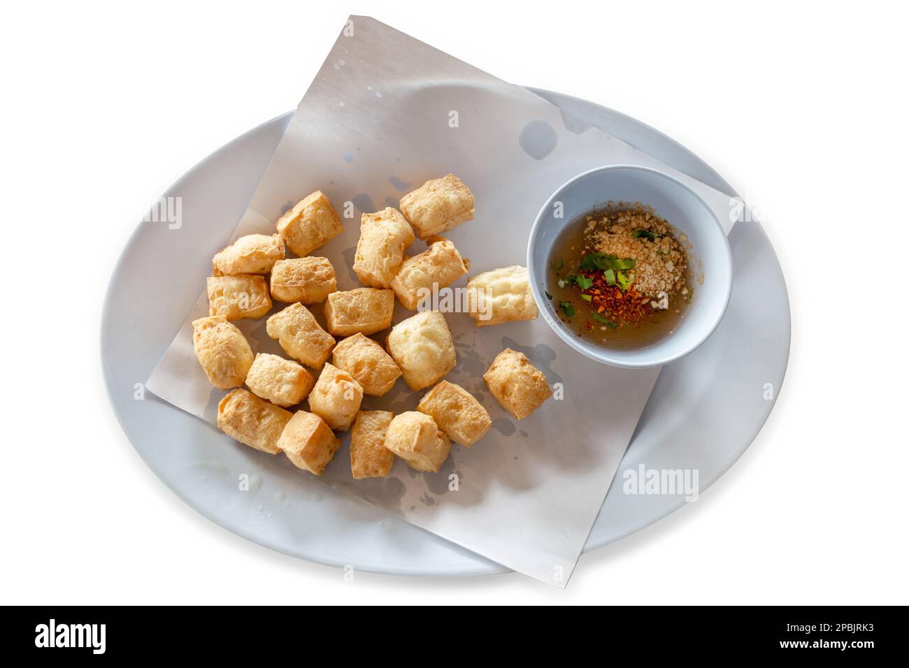 Die cut of fried tofu in dice shape with sweet sauceon white isolated ...
