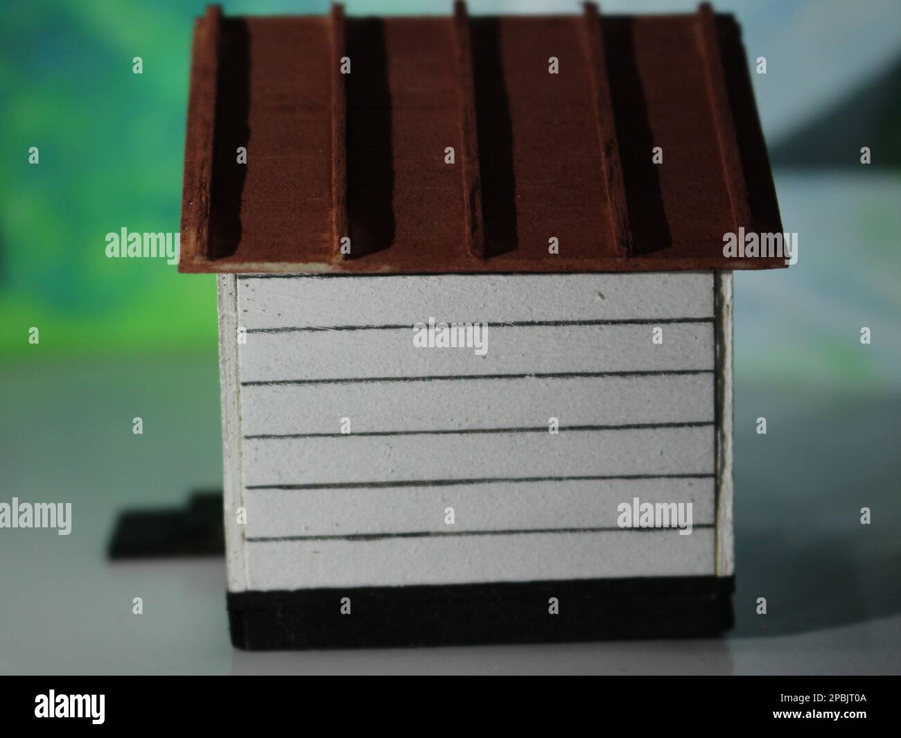 a close up of a miniature figure of a house seen from one side. simple ...