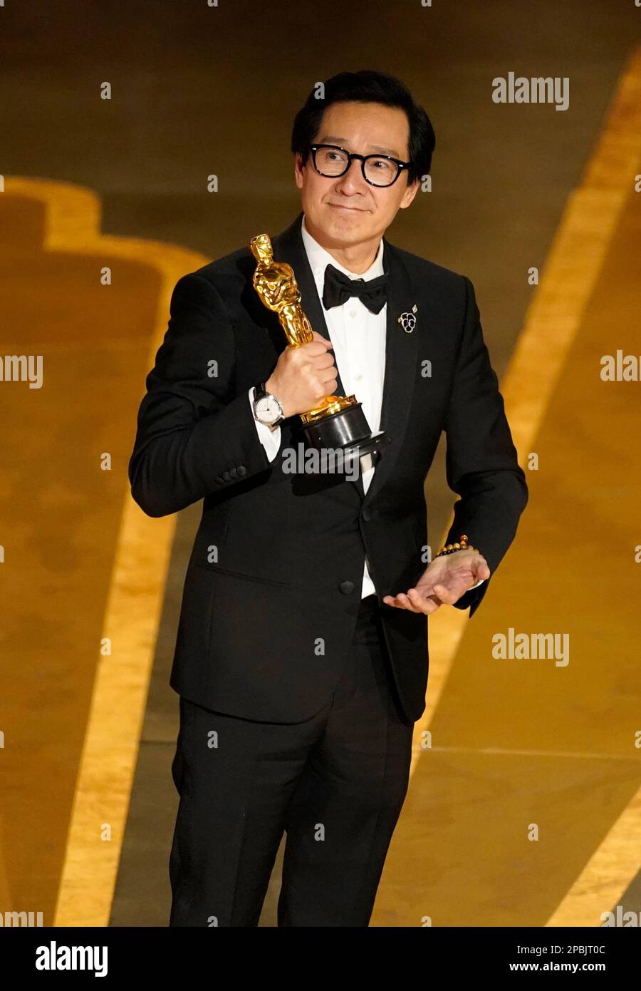 Ke Huy Quan poses onstage with the award for best performance by an ...