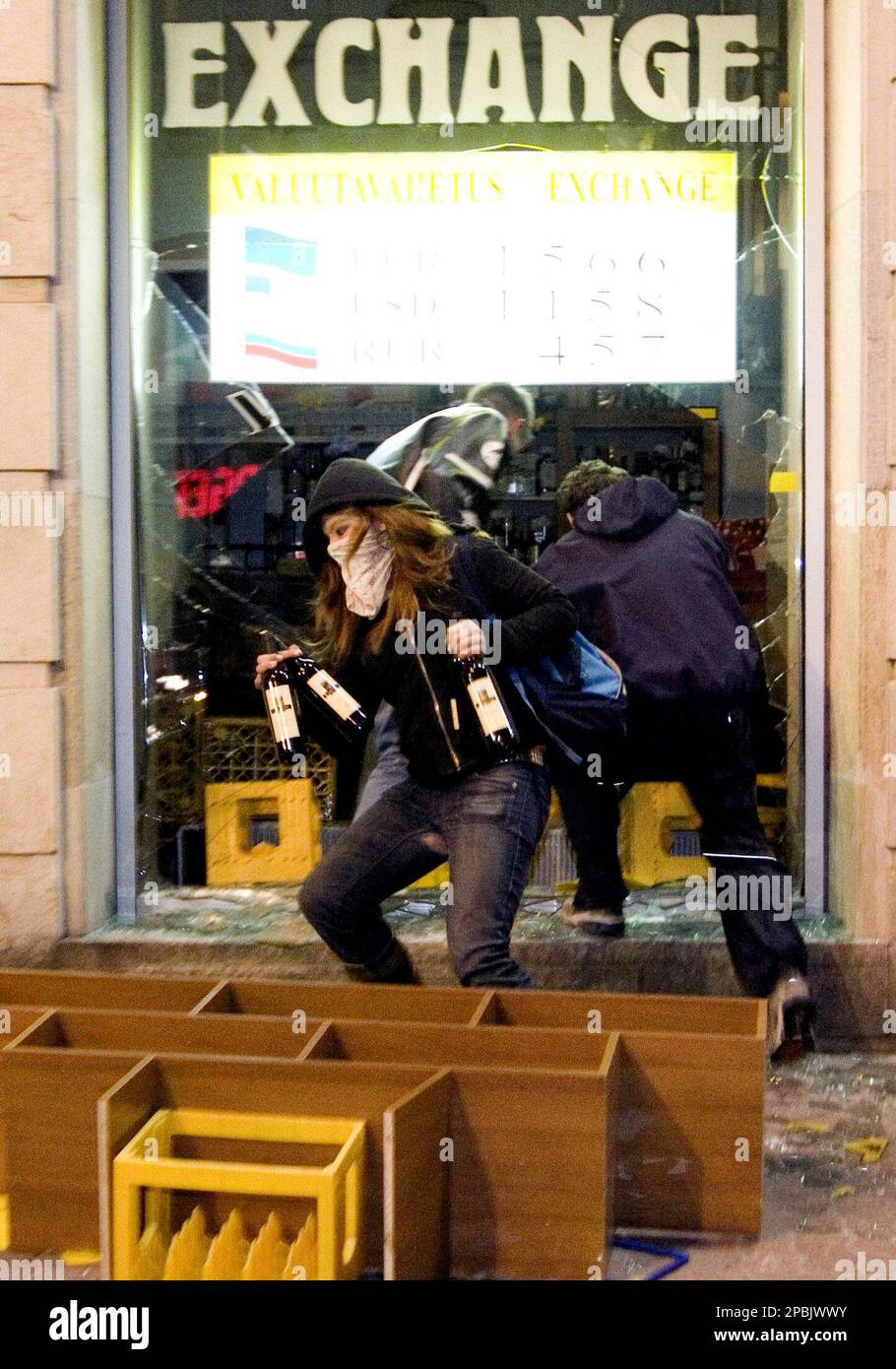Looters loot a liquor store in central Tallinn during the second night ...