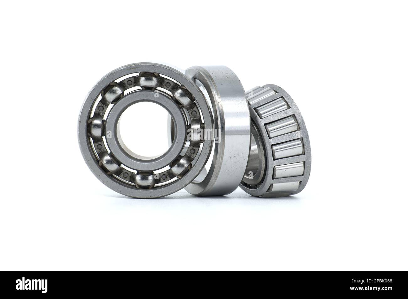 Ball bearing and tapered roller bearing isolated on white background ...