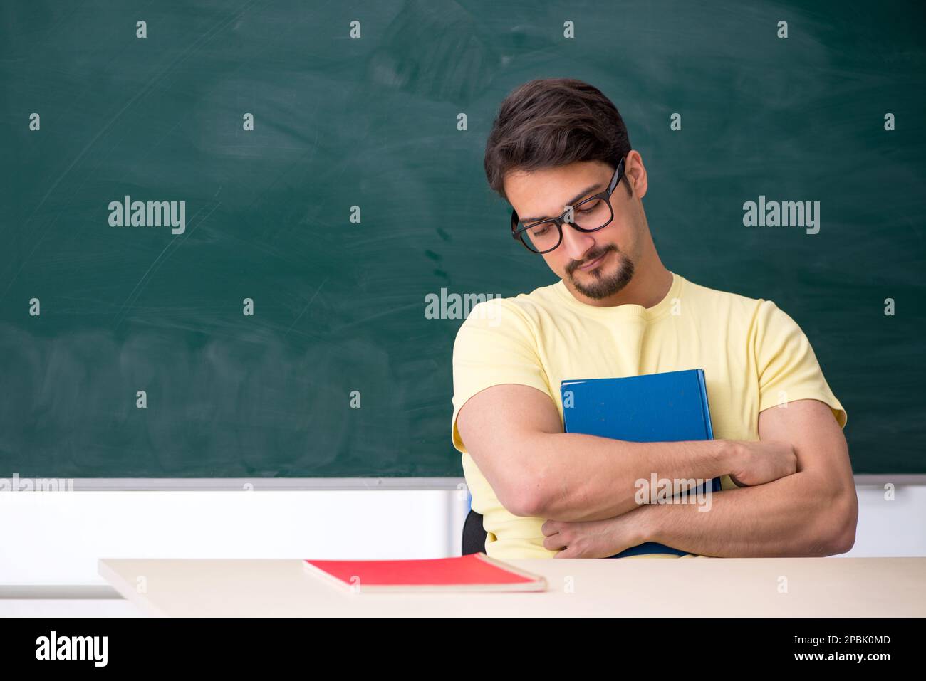 Young student in front of blackboard Stock Photo - Alamy