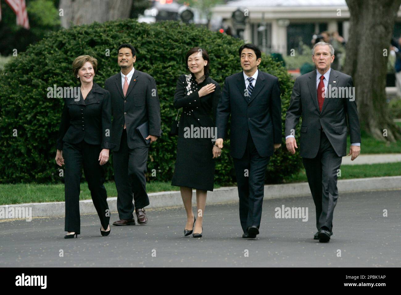 President Bush, right, and first lady Laura Bush, left, escorts ...