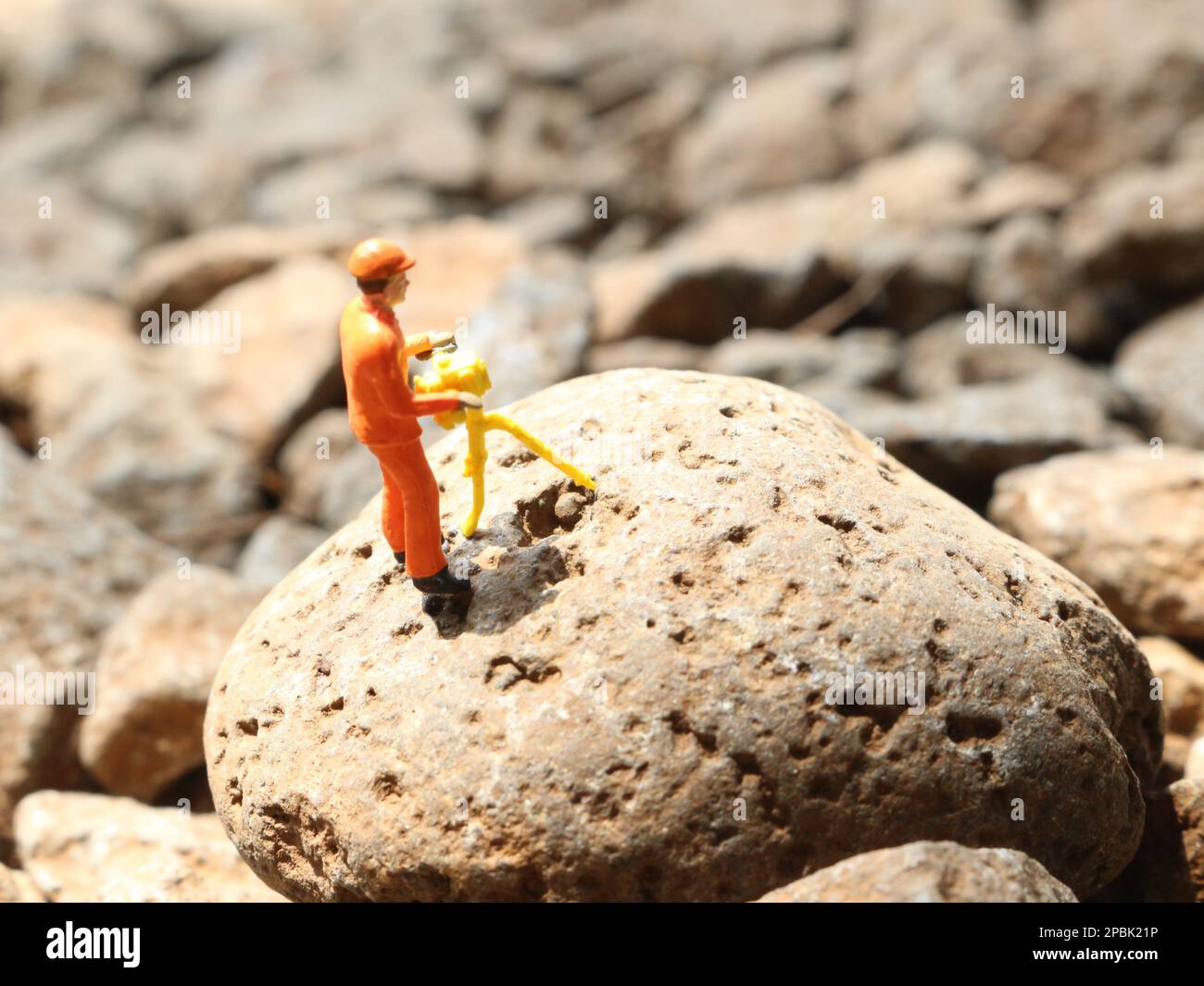 a close up of miniature figures of miners crushing rock. Mining photo ...