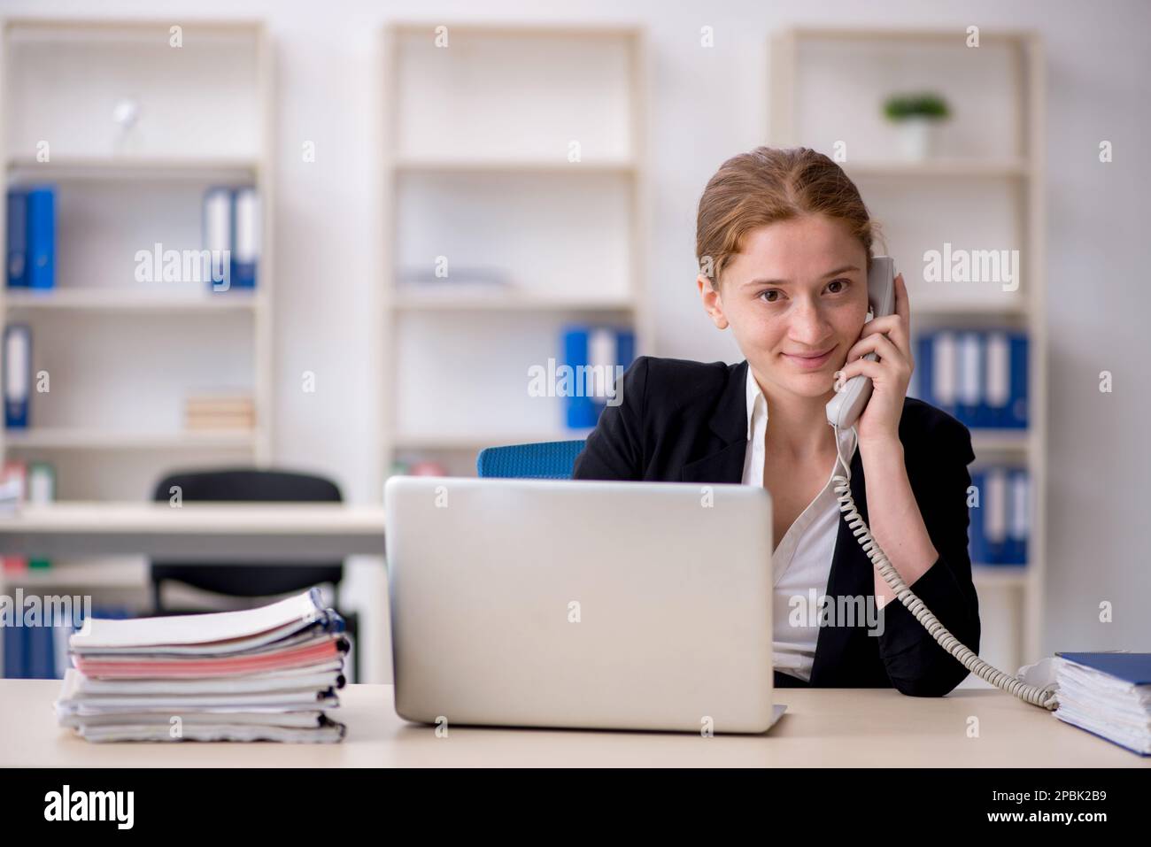 Female employee sitting at workplace Stock Photo - Alamy