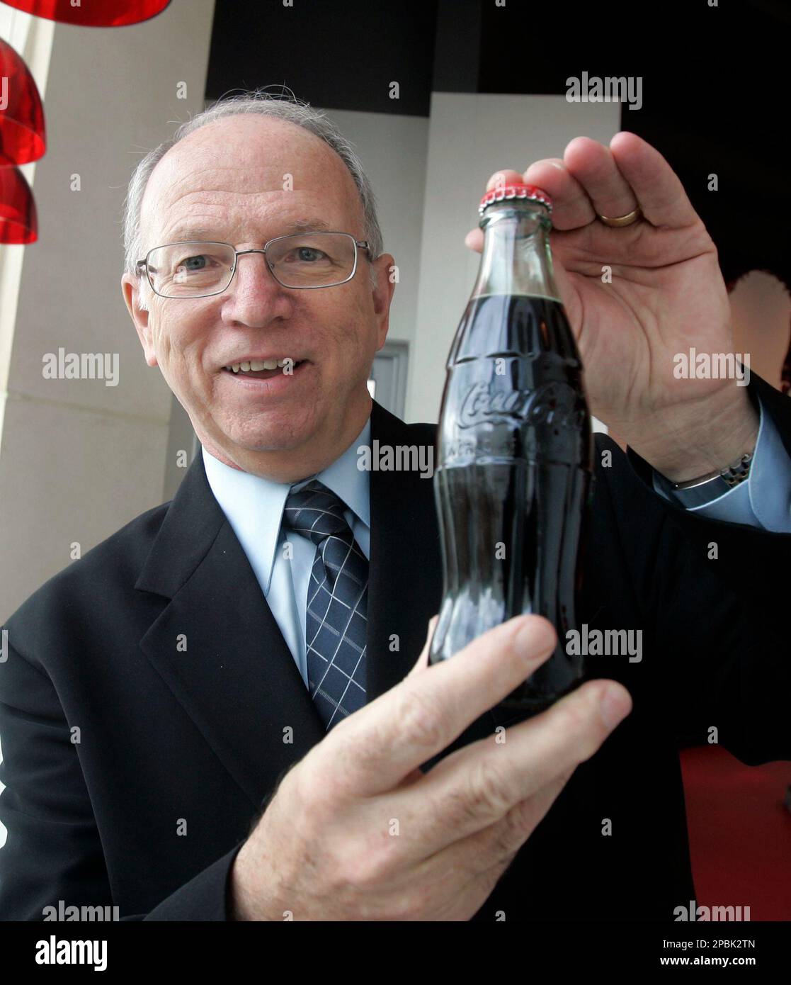 Coca-Cola company archivist Phil Mooney holds a special edition bottle ...