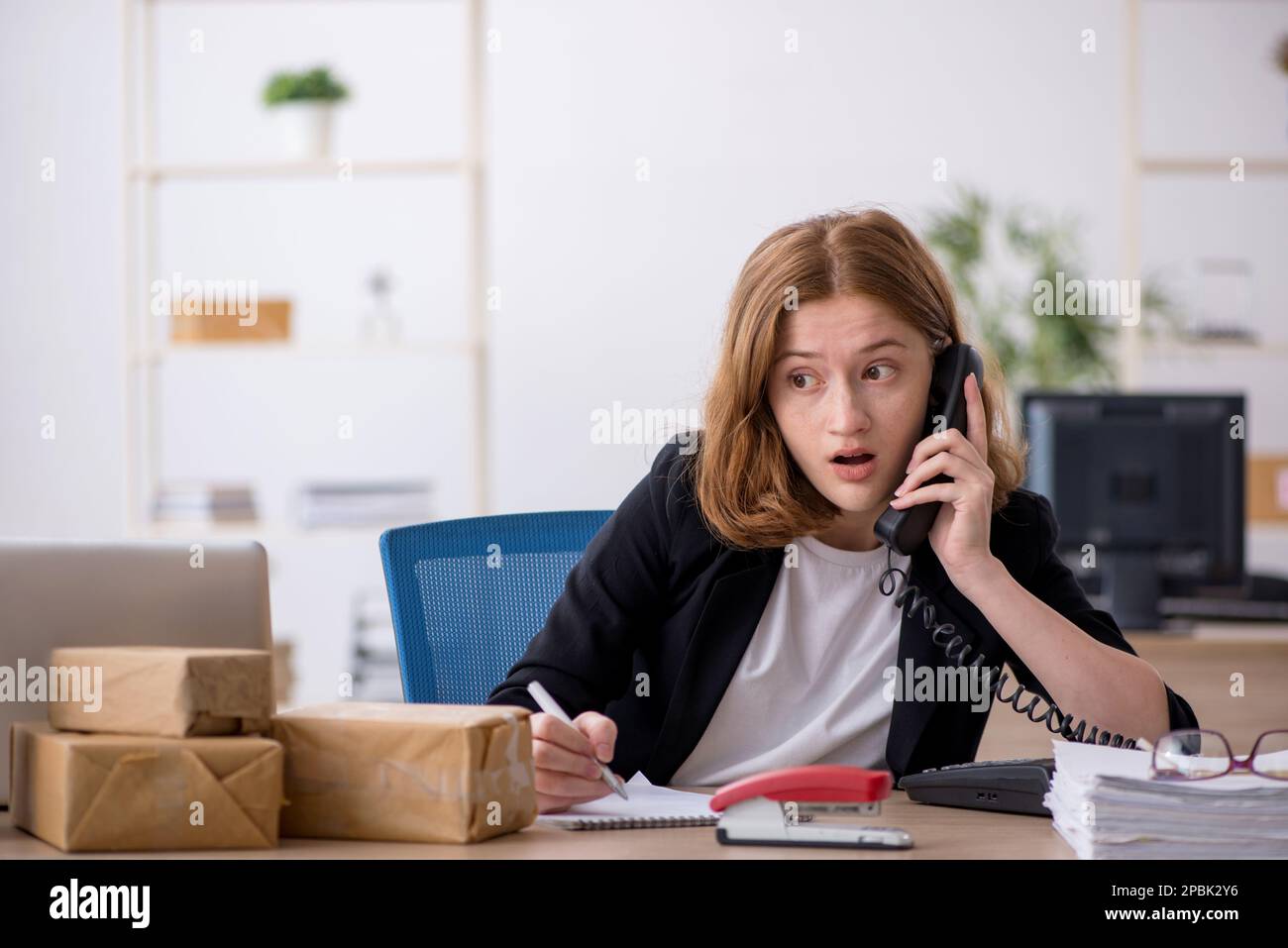 Young businesswoman working in box delivery service Stock Photo - Alamy