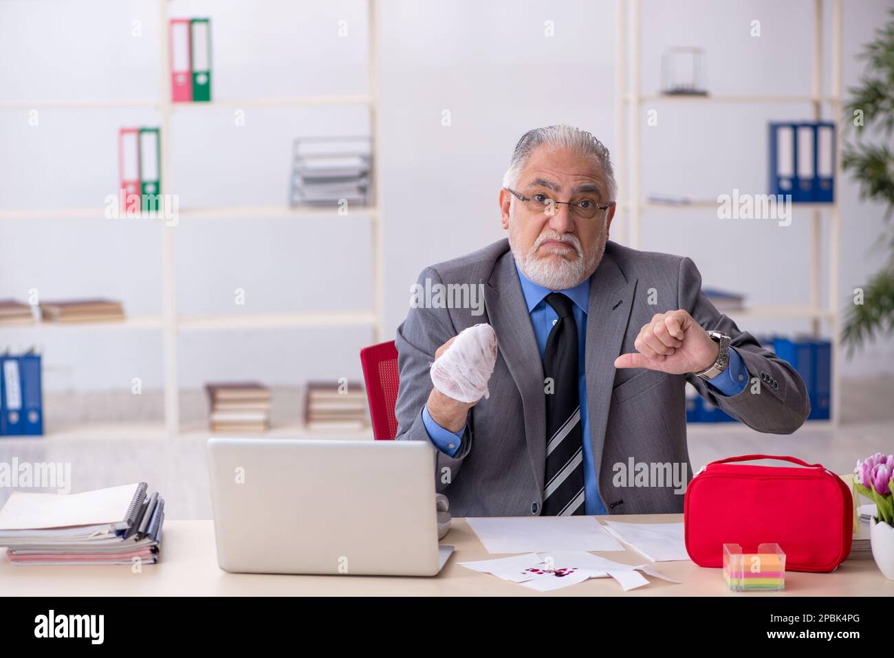 Old businessman employee cutting his hand at workplace Stock Photo - Alamy