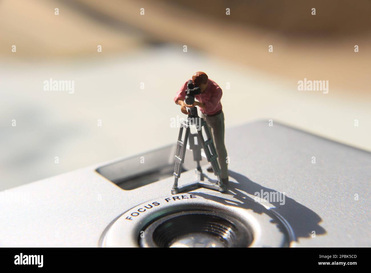 miniature figure of a videographer recording on an analog camera Stock ...