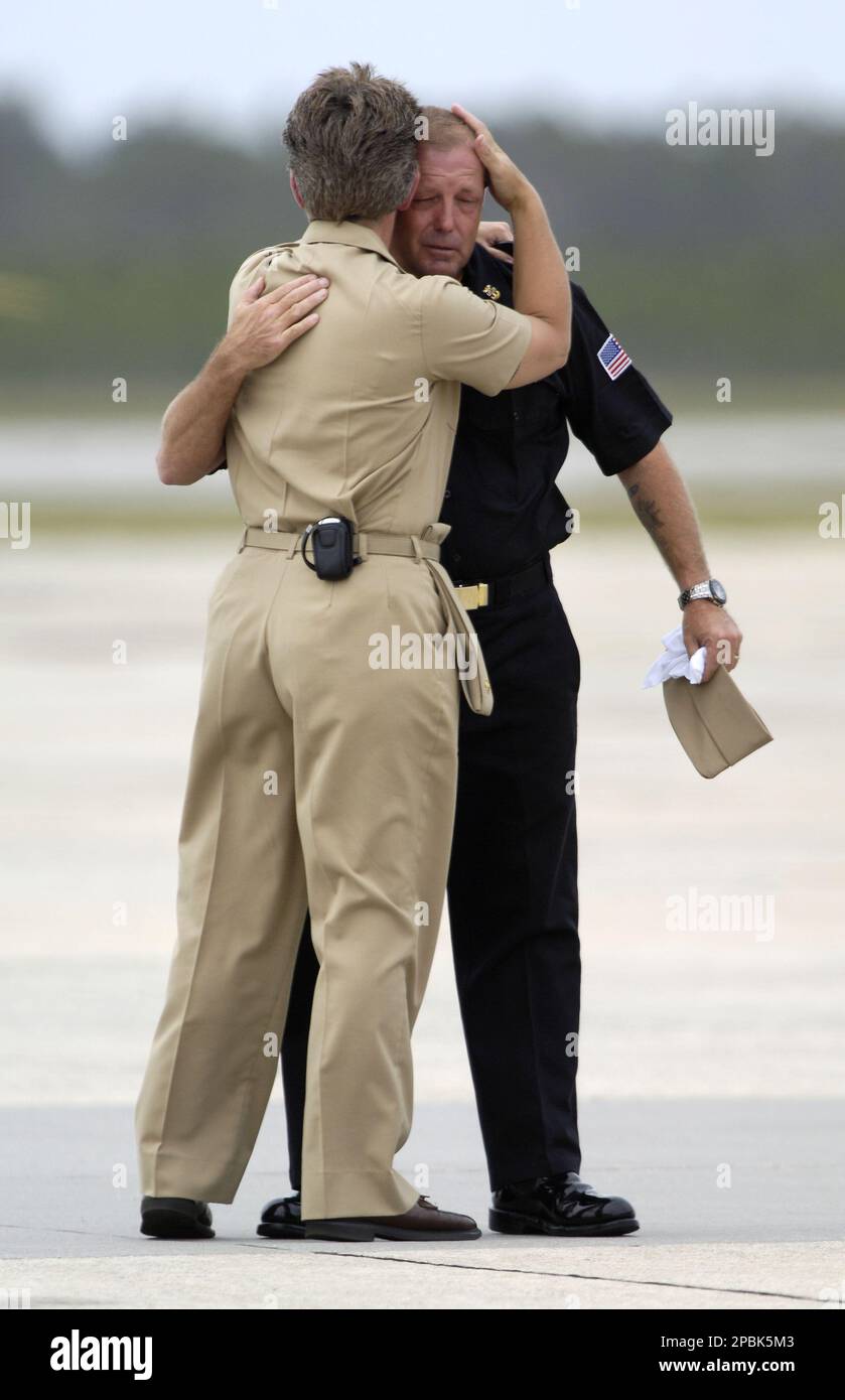 Karen Marini, left, comforts Maintenance Master Chief Jerry Welsh at ...