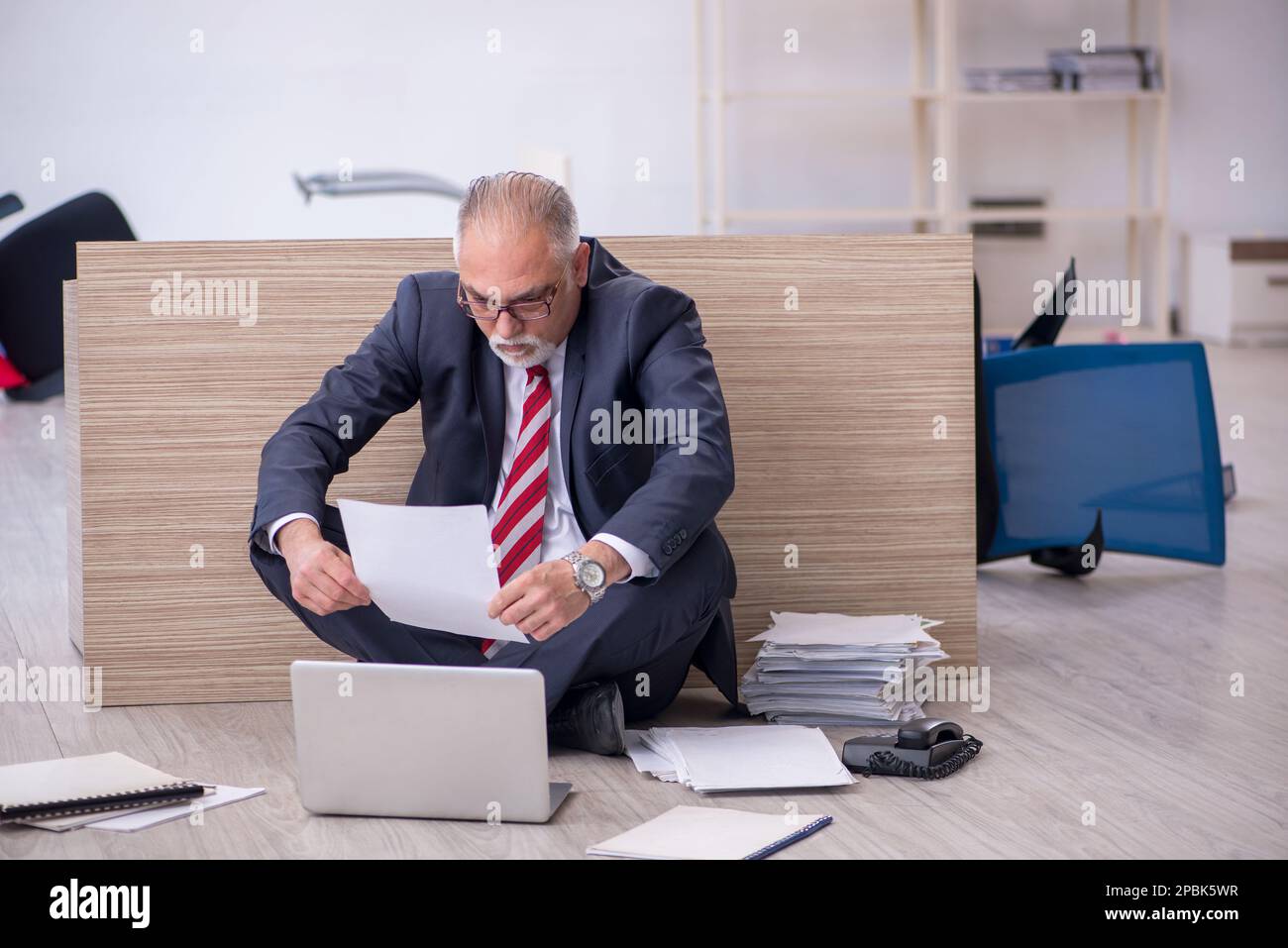 Old businessman employee working overtime at workplace Stock Photo - Alamy