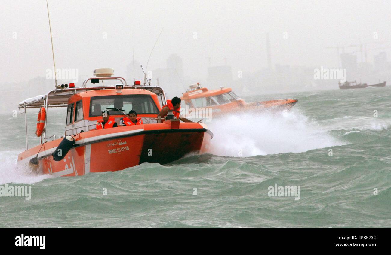A Kuwait Fire Services rescue power boat approaches a floating service ...