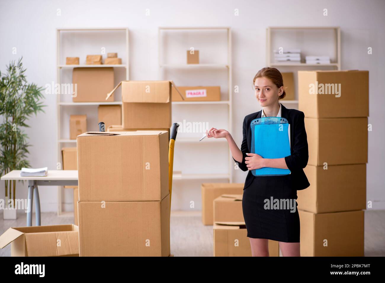 Female professional mover doing home relocation Stock Photo - Alamy