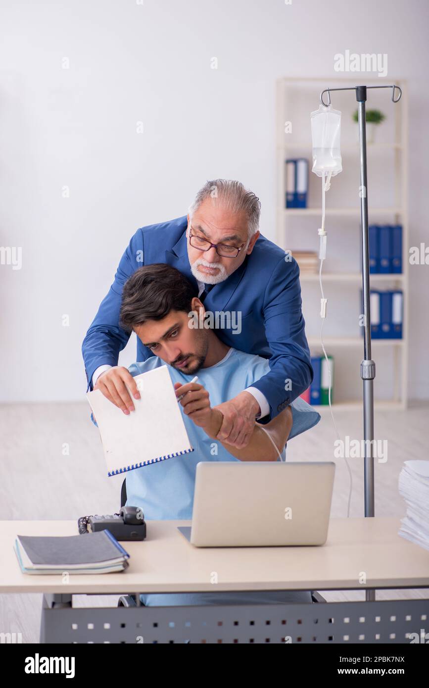 Young employee feeling bad at workplace Stock Photo - Alamy