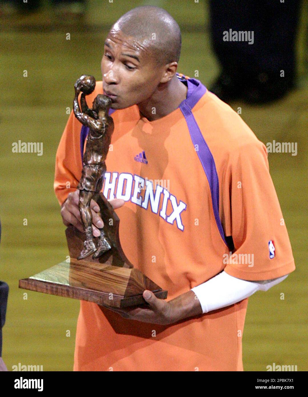 Phoenix Suns' Leandro Barbosa, of Brazil, holds kisses his trophy after ...