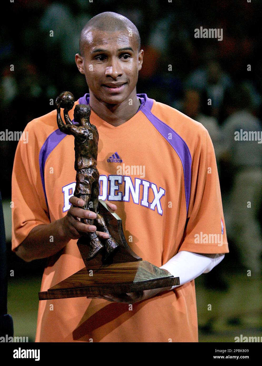 Phoenix Suns' Leandro Barbosa, of Brazil, holds up his trophy after ...