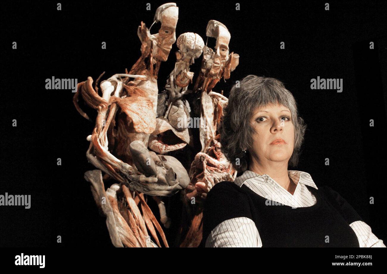 Susan Baxter poses with a plastinated body at the "Body Worlds" exhibit ...