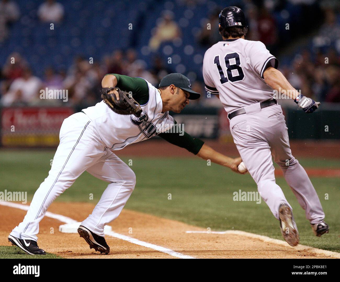 Tampa Bay Devil Rays first baseman Carlos Pena, left, tags out New York ...