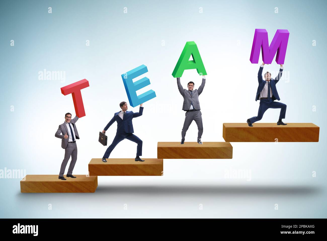 Teamwork concept with the people carrying team letters Stock Photo - Alamy