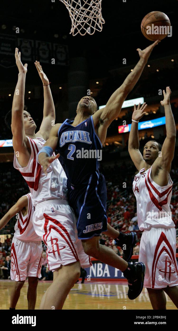 Utah Jazz's Derek Fisher (2) goes up for a shot between Houston Rockets ...